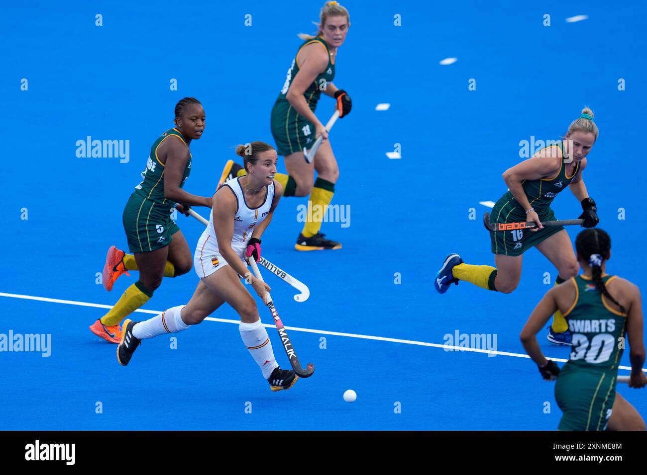 Spain's Belen Iglesias, center, drives the ball past South Africa's ...