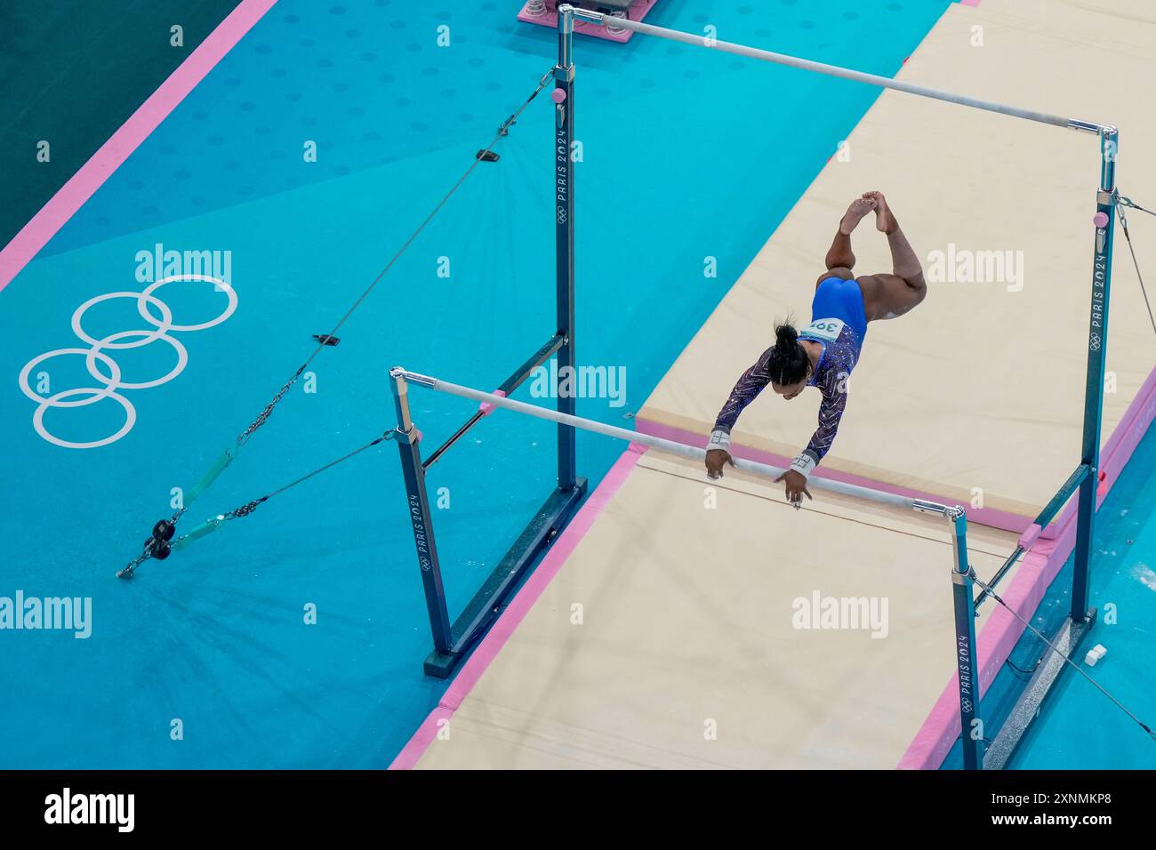 Simone Biles, of the United States, performs on the uneven bars during ...