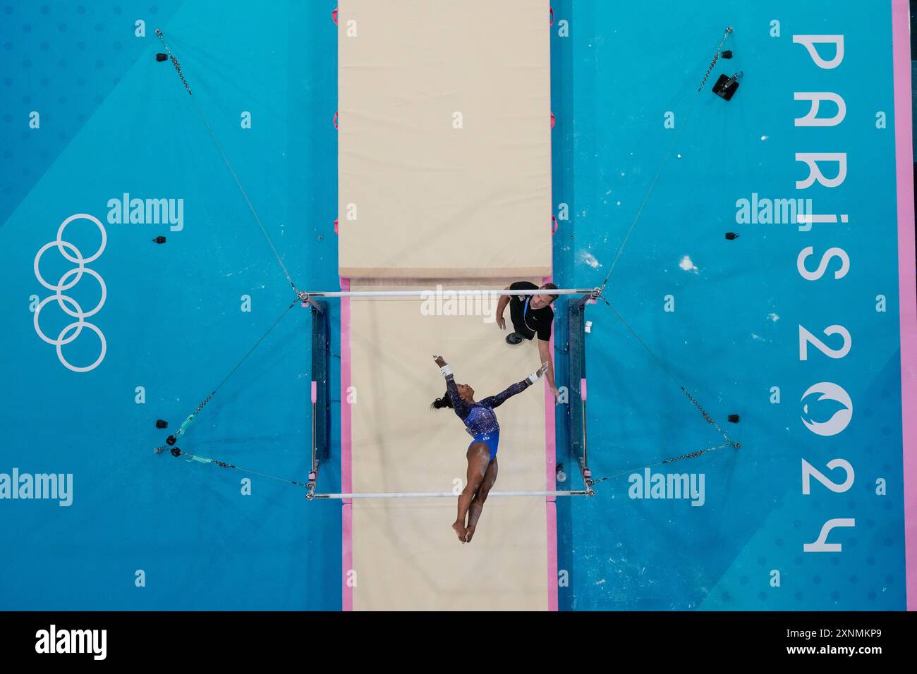 Simone Biles, of the United States, performs on the uneven bars during ...