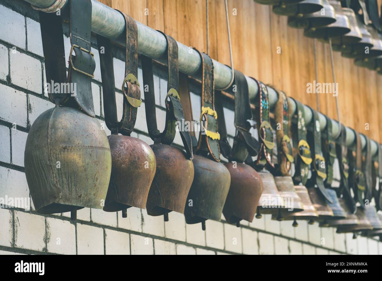 Authentic Swiss cowbells hanging up in storage Stock Photo - Alamy