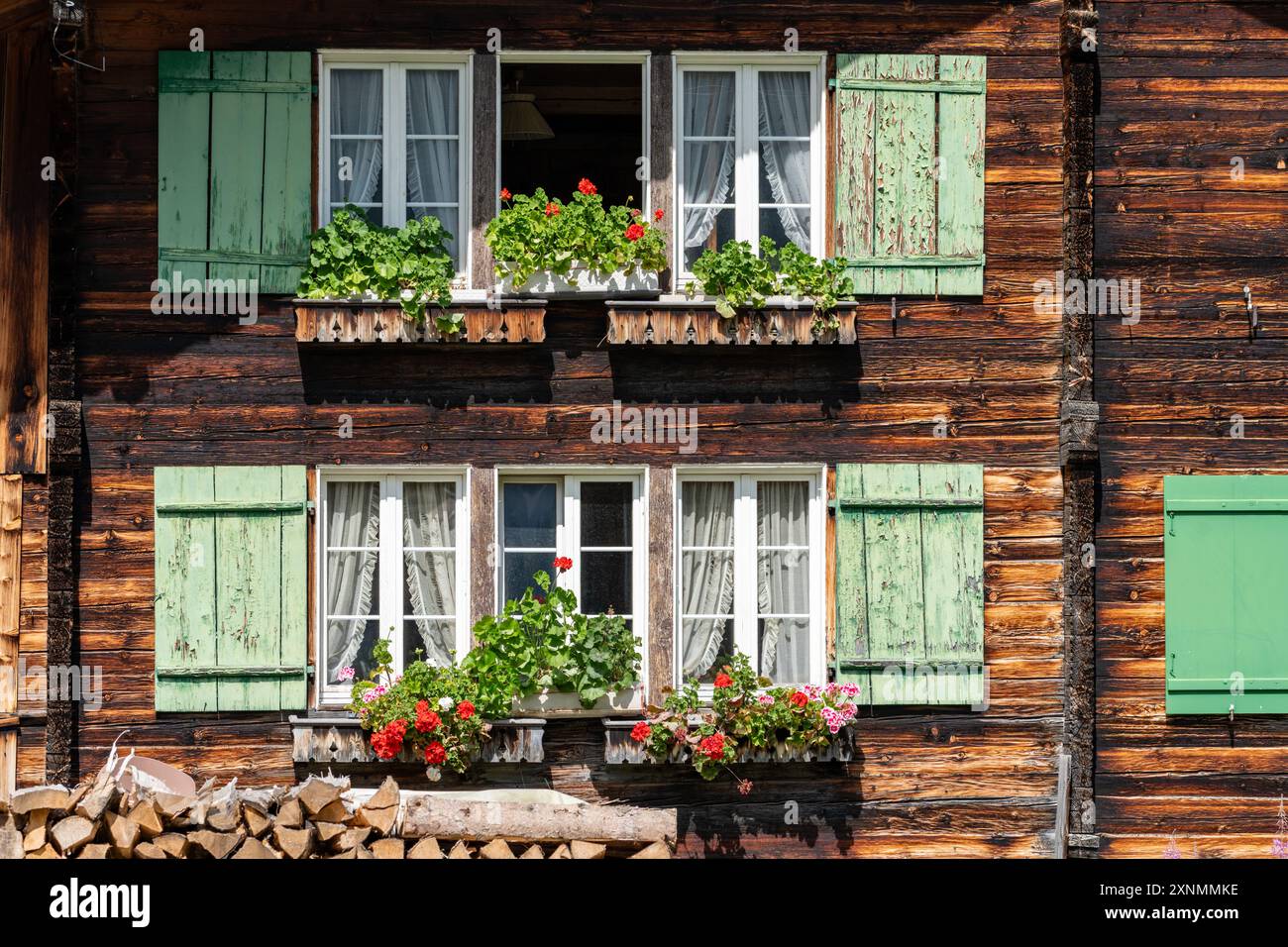 Traditional Swiss chalet home in Gimmelwald, with green shutters and ...