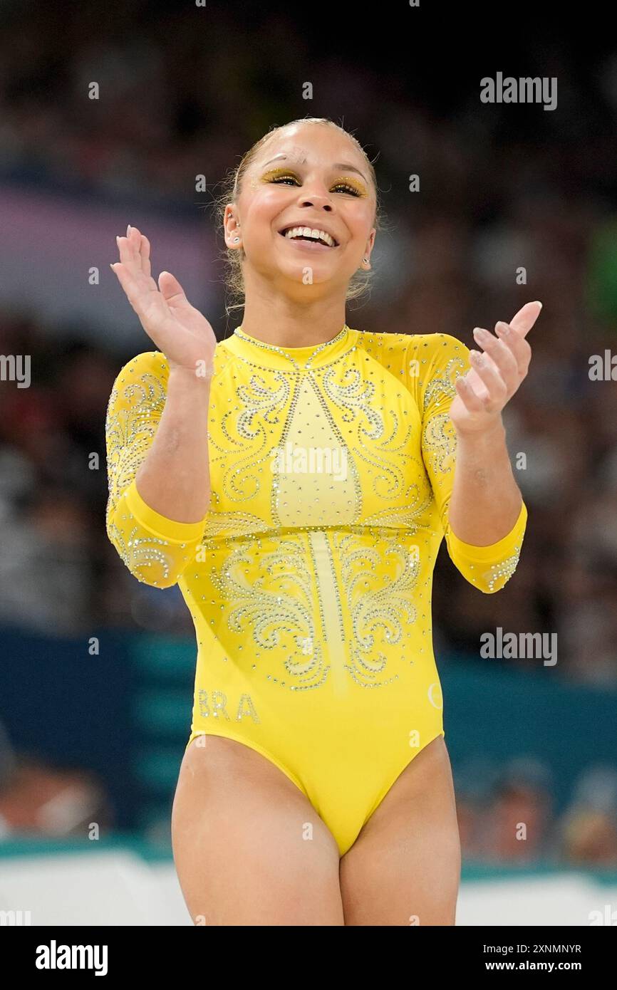 Flavia Saraiva, of Brazil, smiles after performing on the balance beam ...