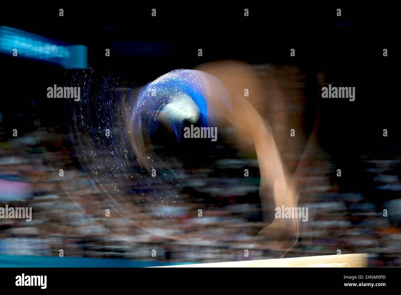 In this photo made with a slow shutter speed, Simone Biles, of the ...