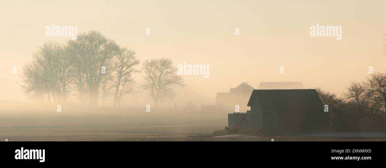 An early morning with low fog covering farms in a valley Stock Photo ...