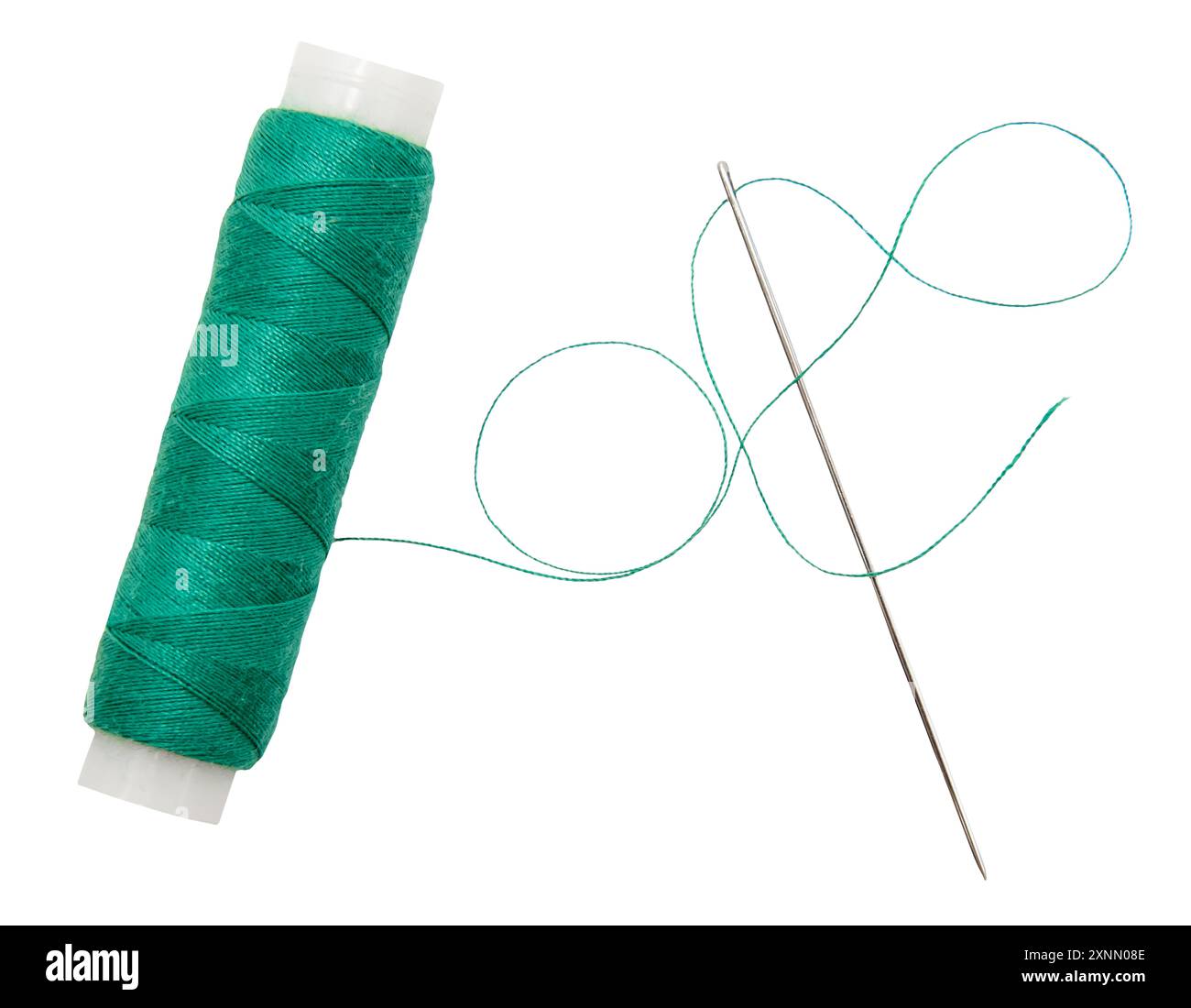 Old spool of thread and needle on a white background. Sewing ...