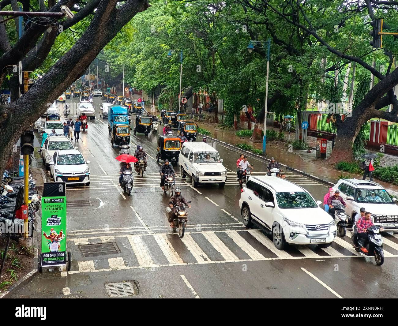 PUNE, INDIA - July 30, 2024: Traffic of Motorcycles and Cars on Jangali ...
