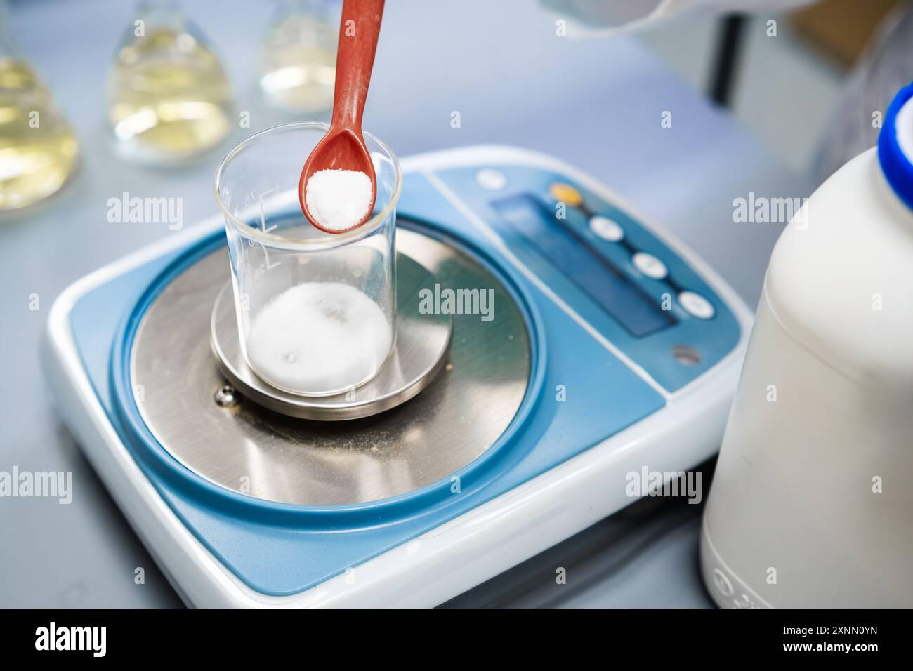 Using laboratory balances, a researcher weighs powder samples Stock ...