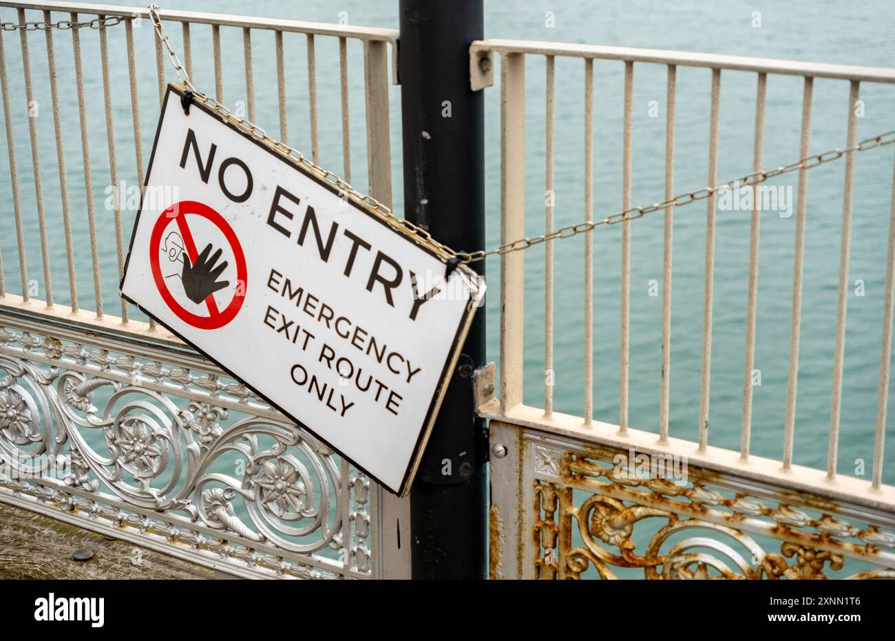 Close and selective focus of a no entry sign on the railings of ...