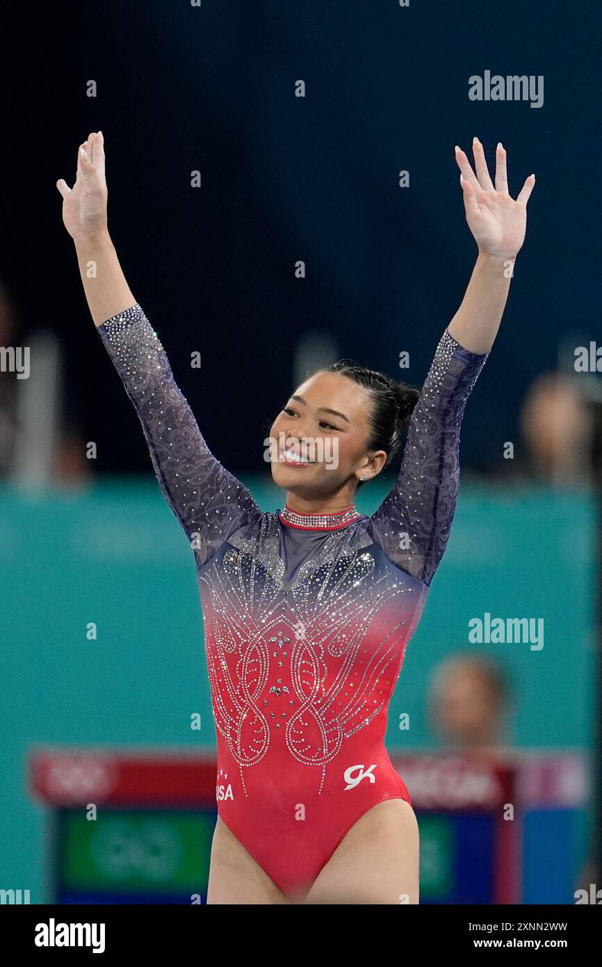 Suni Lee, of the United States, smiles after performing on the floor ...