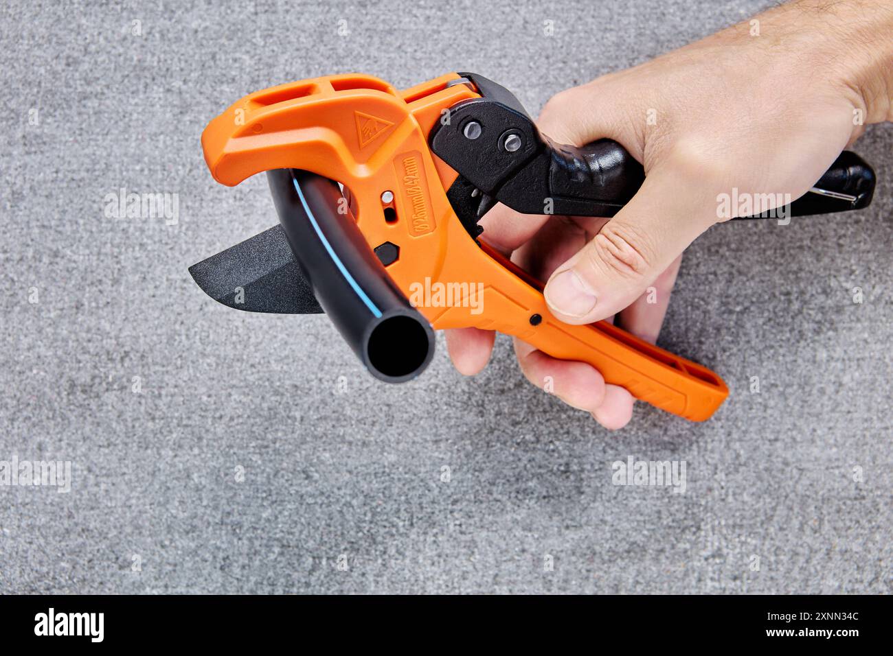 Hand of plumber holds pipeline scissors cutter with ratchet mechanism ...