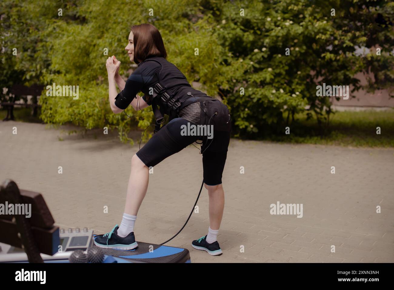 Woman in Street EMS Workout - Electrifying Fitness. step platform ...