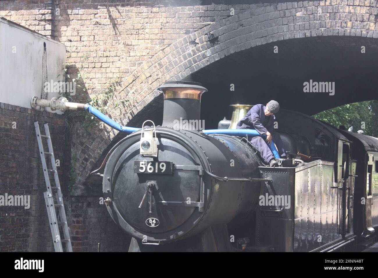 Pouring water into a steam locomotive on the Telford Steam Railway ...