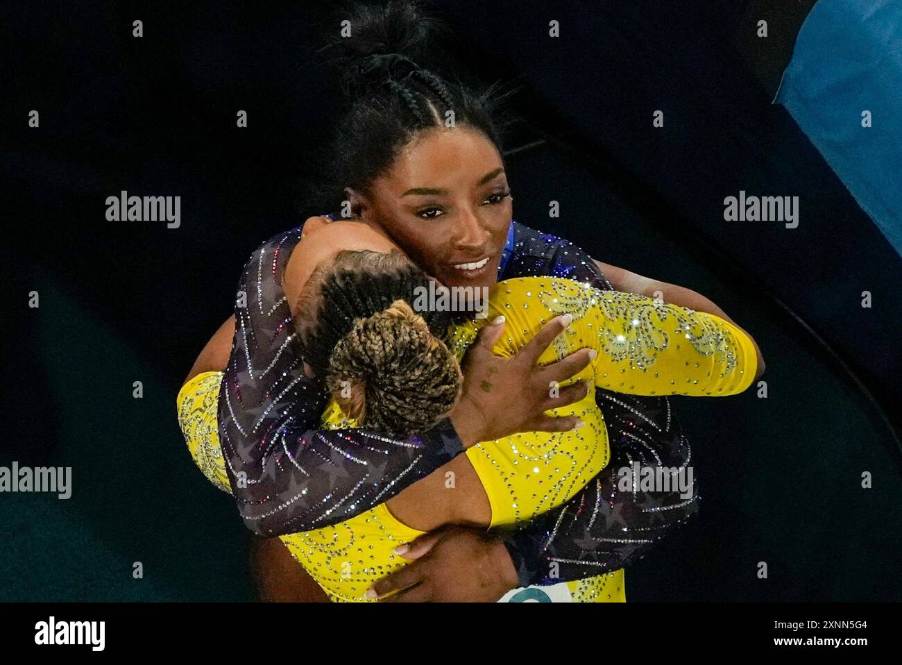 Simone Biles, of the United States, hugs Rebeca Andrade, of Brazil ...