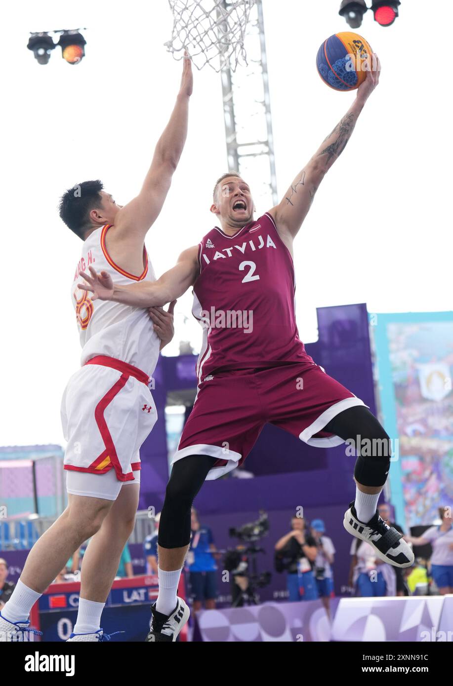 Paris, France. 1st Aug, 2024. Karlis Lasmanis (R) of Latvia makes a layup during the 3x3 ...
