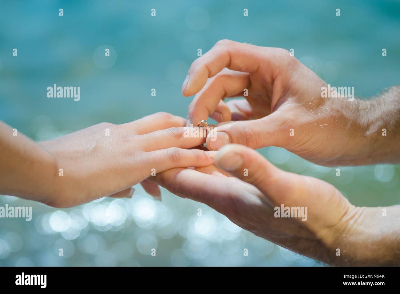 guy's hand puts an wedding ring on a girl's hand Stock Photo - Alamy