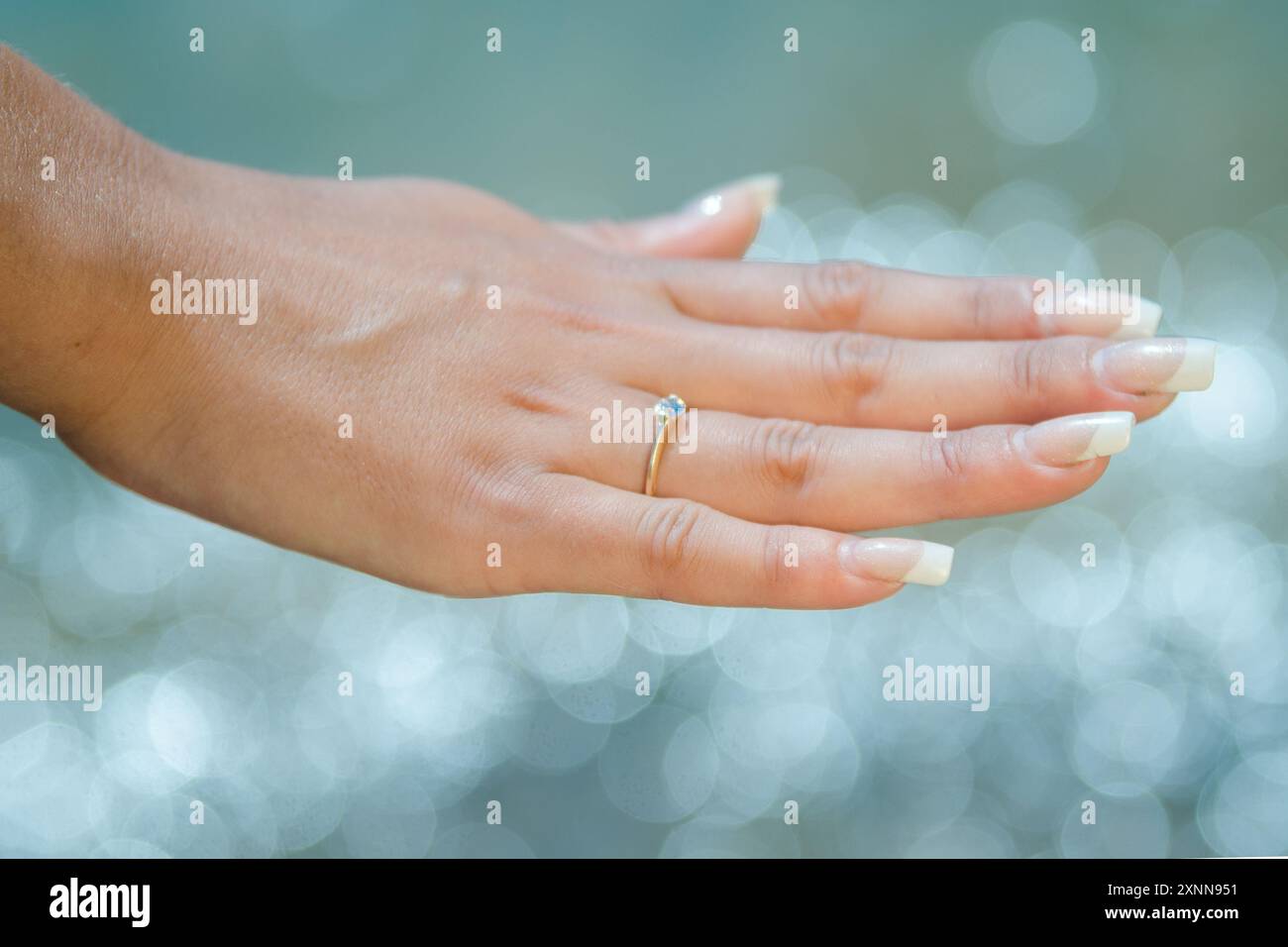 gold wedding ring on the girl's finger Stock Photo - Alamy