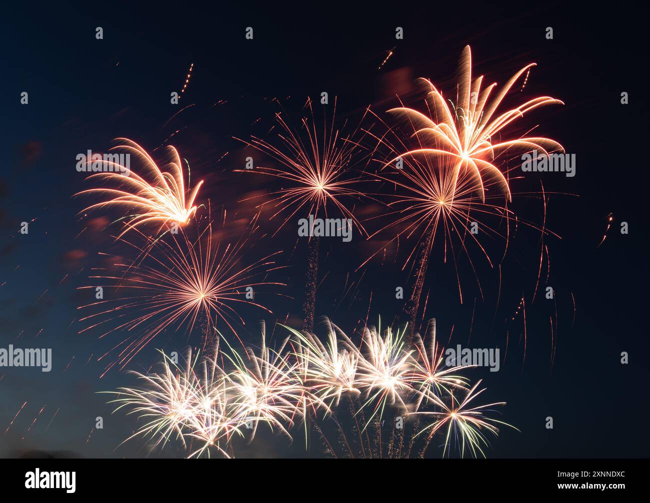 A dazzling display of fireworks lights up the night sky, creating a ...