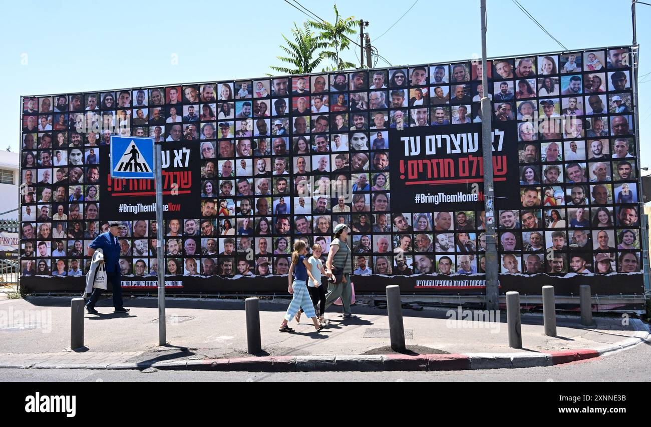 Jerusalem, Israel. 01st Aug, 2024. People walk past a billboard in ...