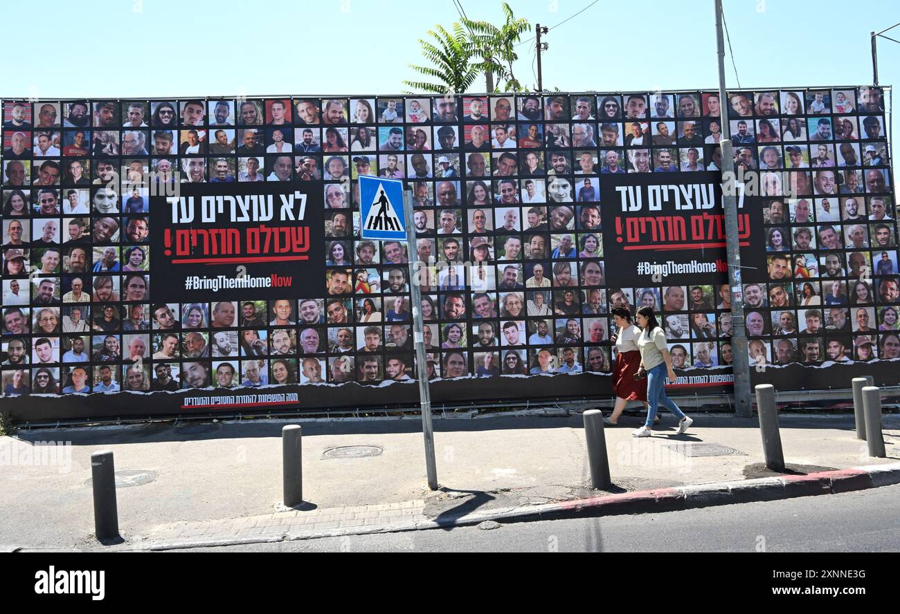 Jerusalem, Israel. 01st Aug, 2024. Women walk past a billboard in ...