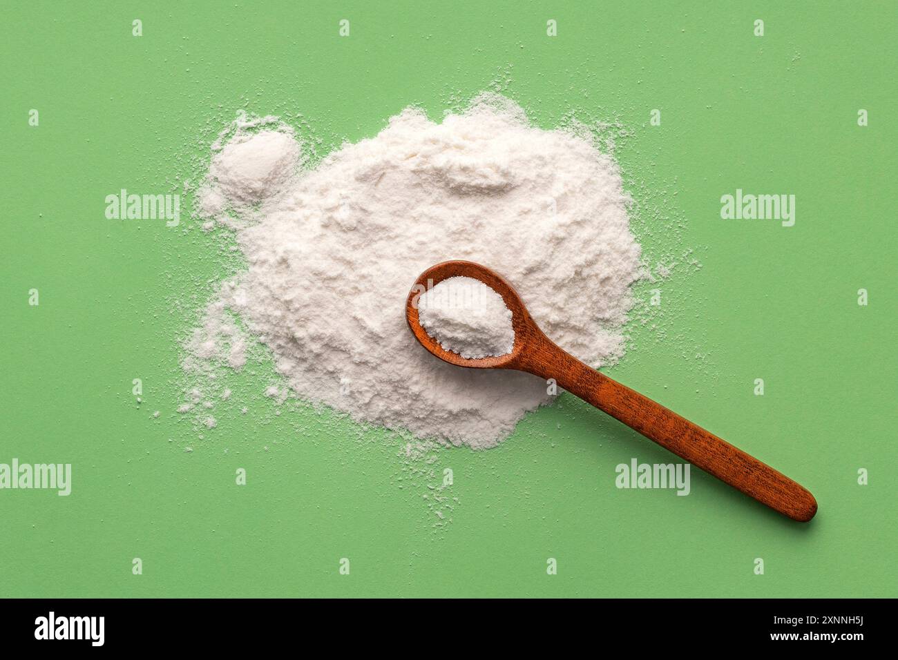 Baking Soda - Crystalline Solid compound in spoon. Green background ...