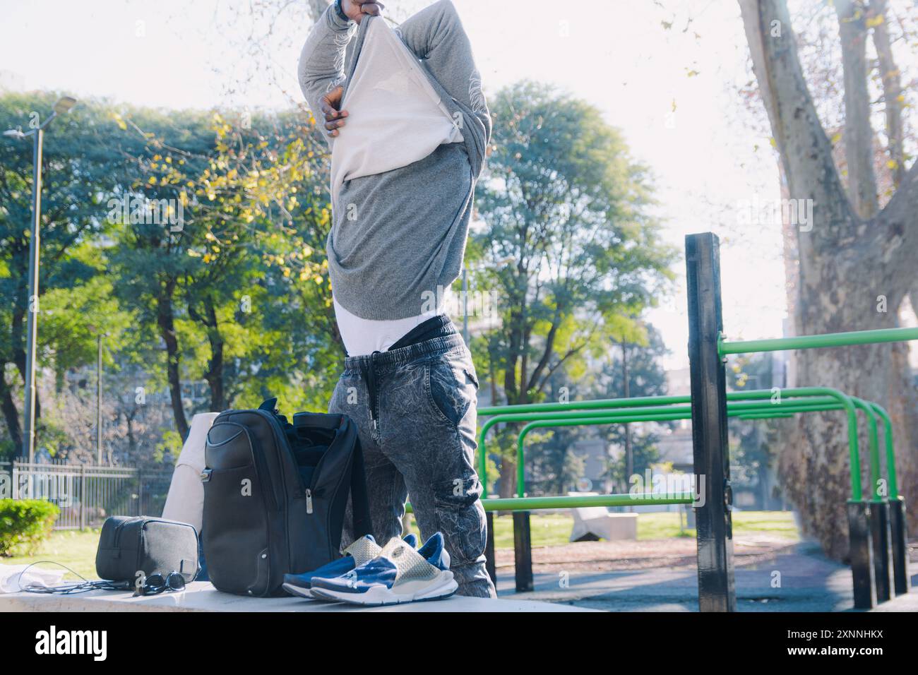 Young Man changing clothes, they are preparing in the park for an ...