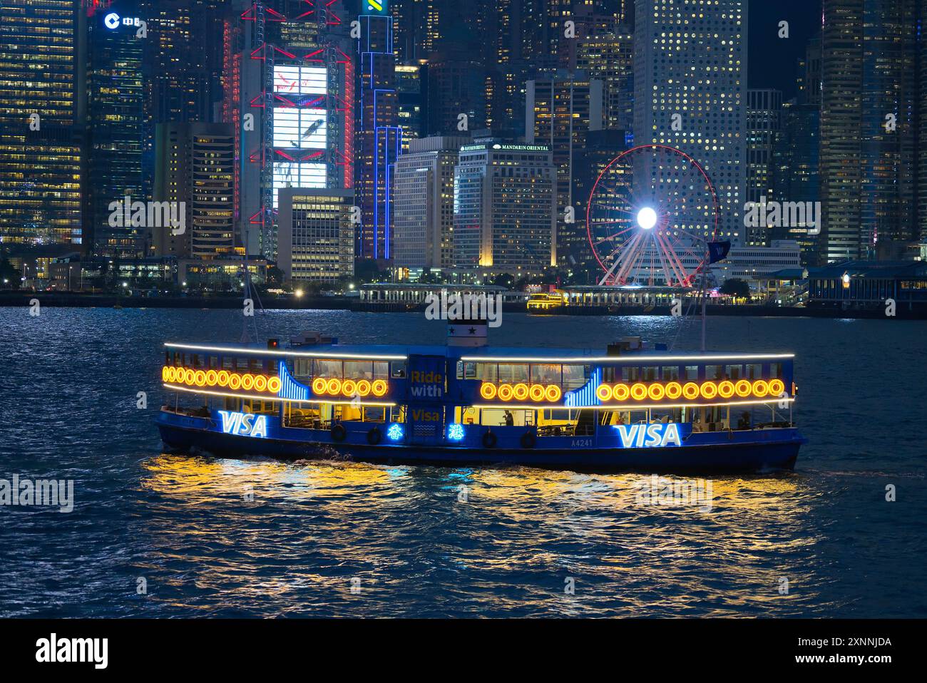 Star Ferry illuminated with the Visa logo on Victoria Harbour at night ...