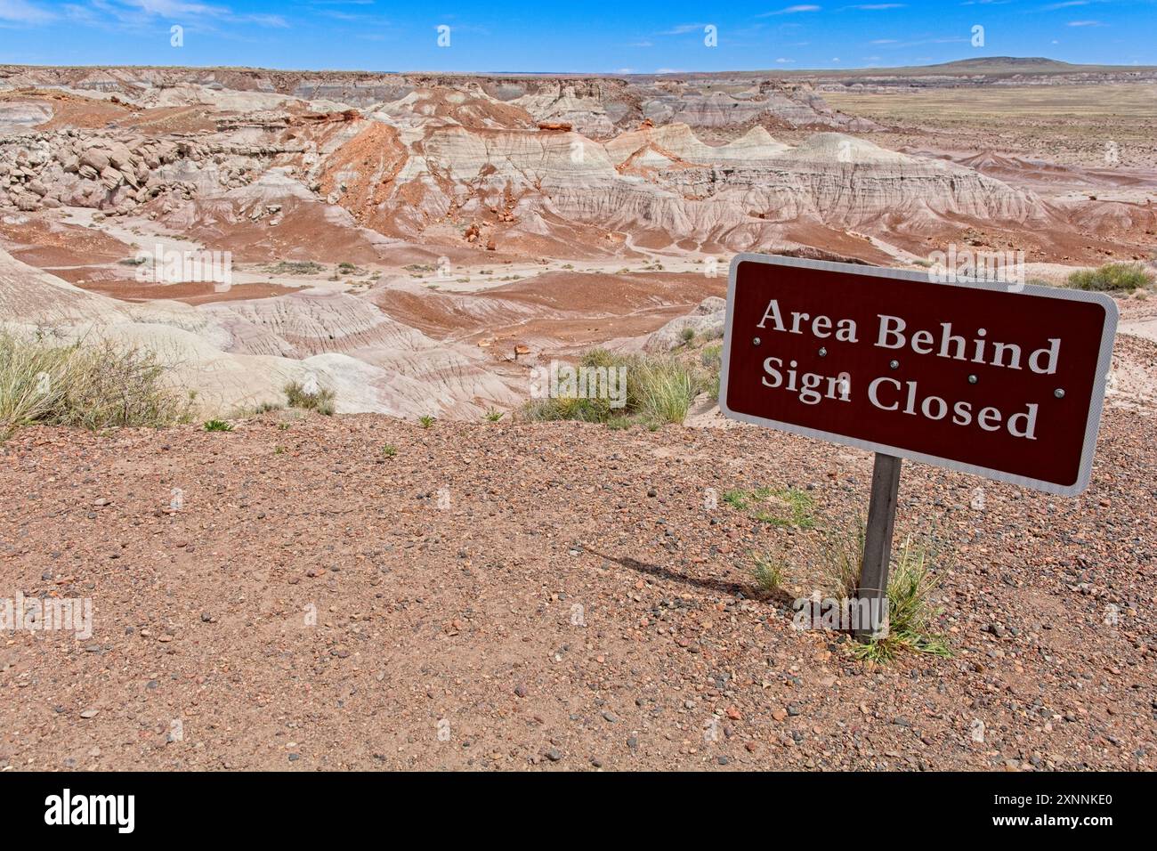 Warning sign for closed area at cliff edge in badlands of Painted ...