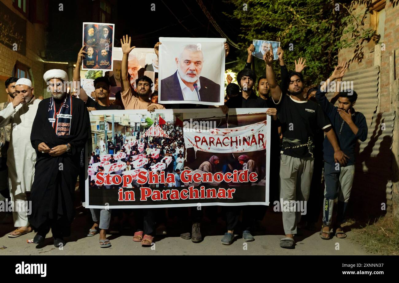 Kashmiri Shia Muslims hold candles, photographs of Ismail Haniya, and a ...