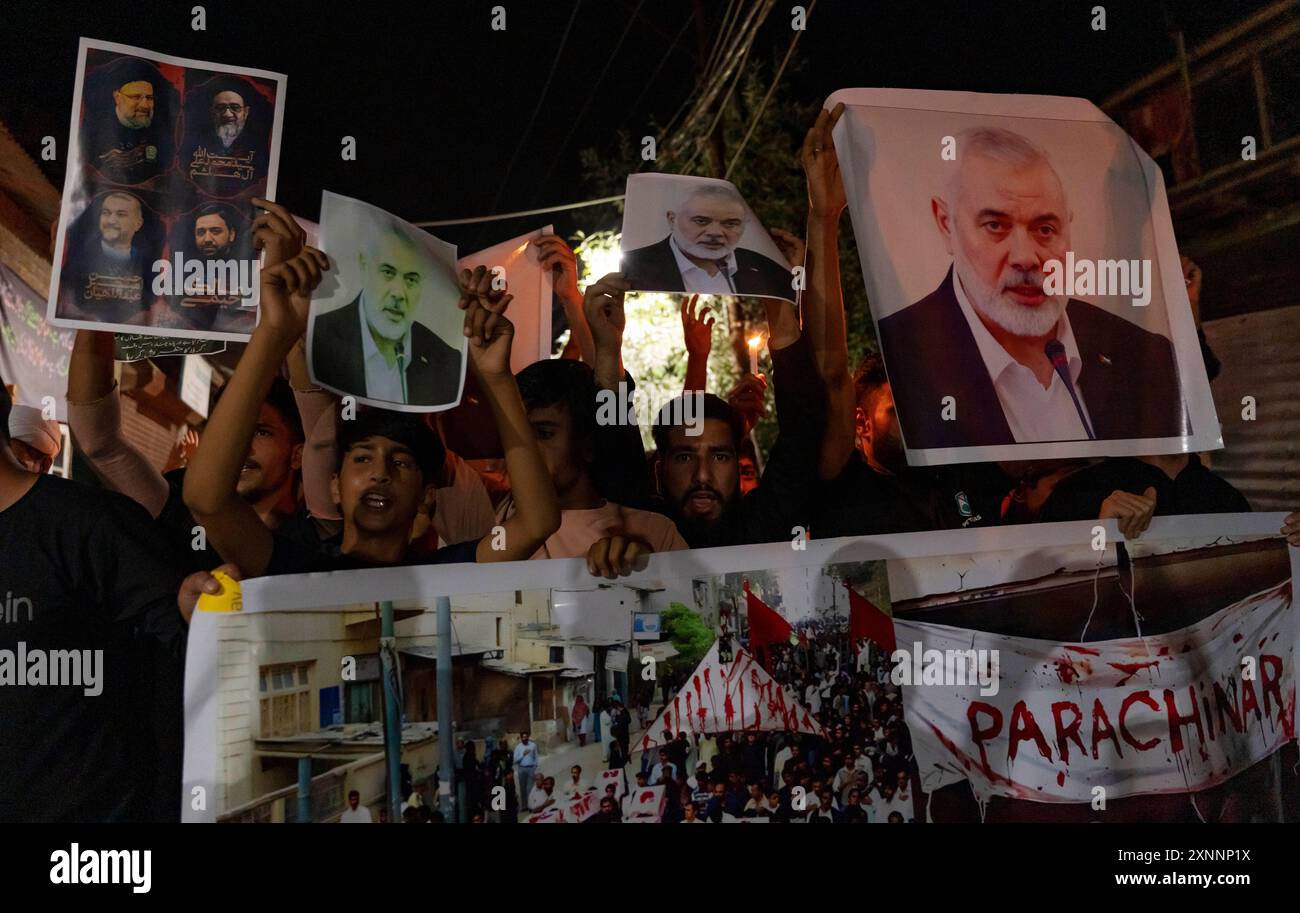 Kashmiri Shia Muslims hold candles, photographs of Ismail Haniya, and a ...