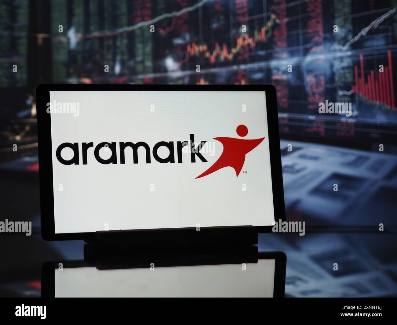 In this photo illustration, an Aramark logo seen displayed on a tablet ...