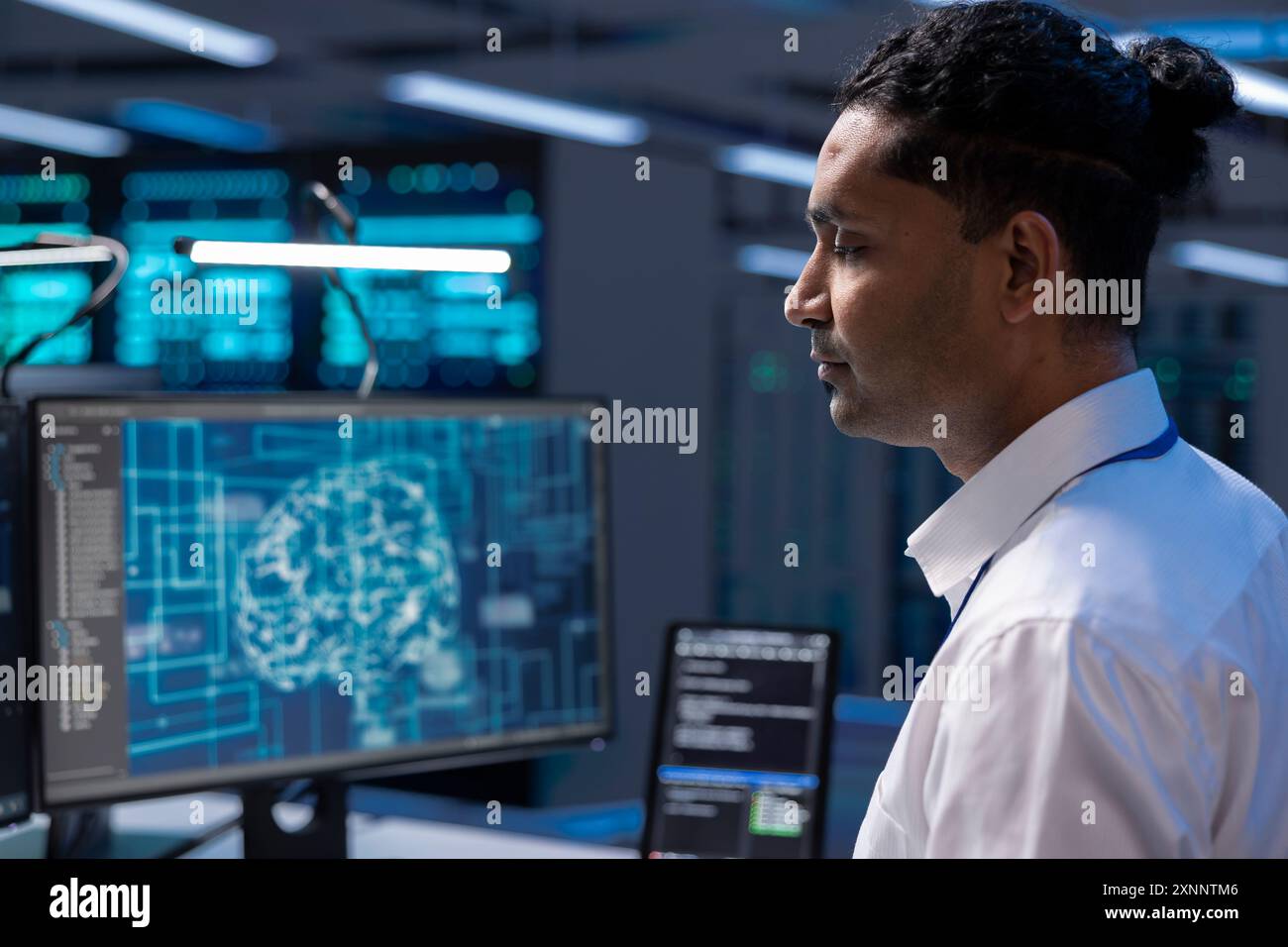 Programmer working on computer in data center with artificial ...