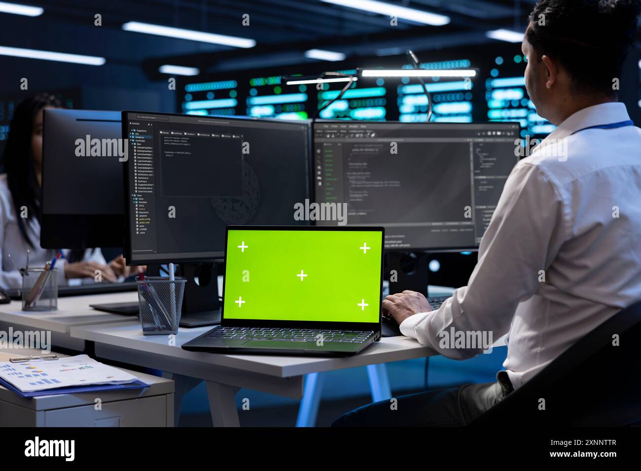 Programmers colleagues using mockup laptop to check server clusters configuration settings ...