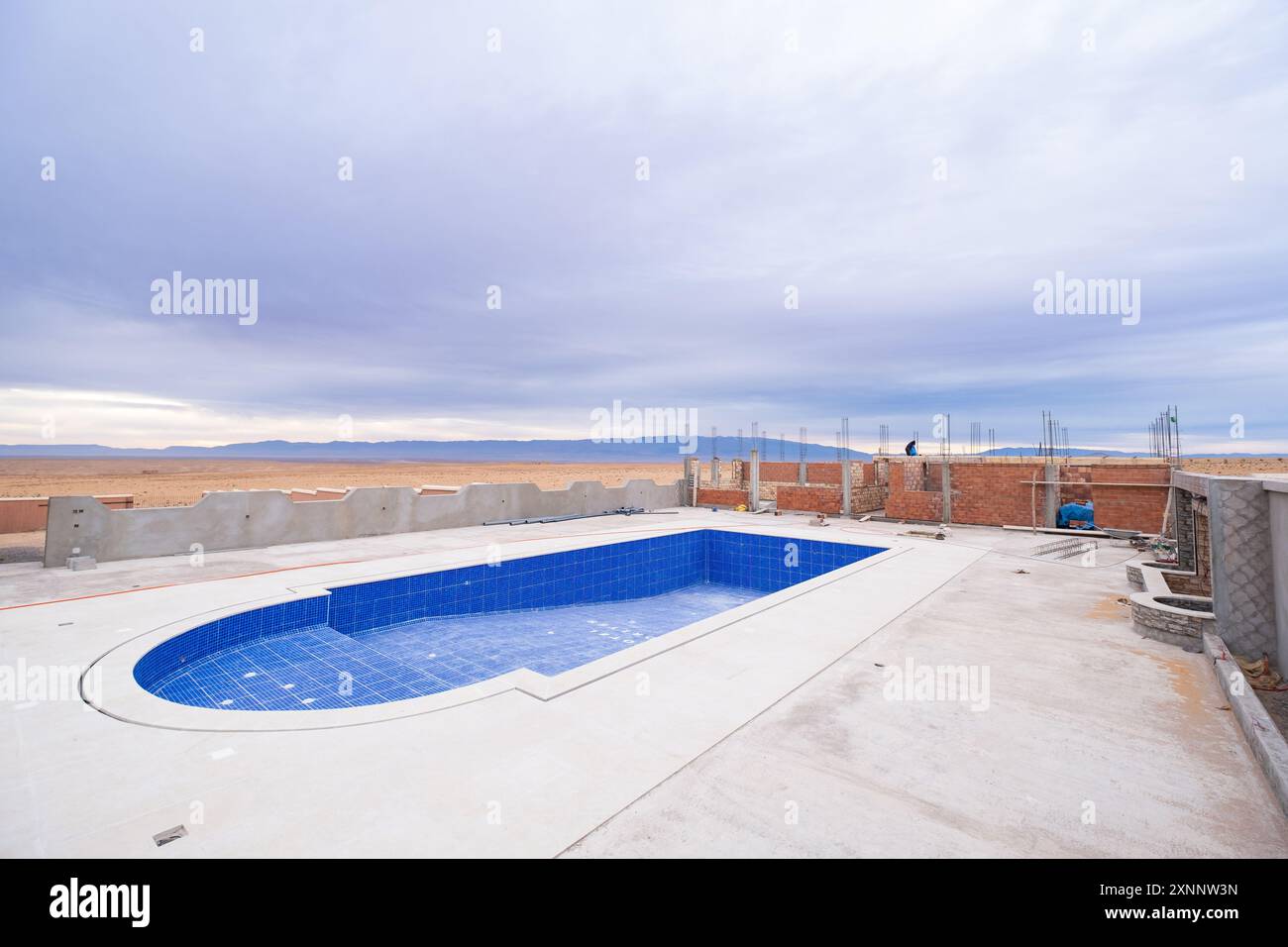 An empty swimming pool under construction, It is dawning in the desert ...