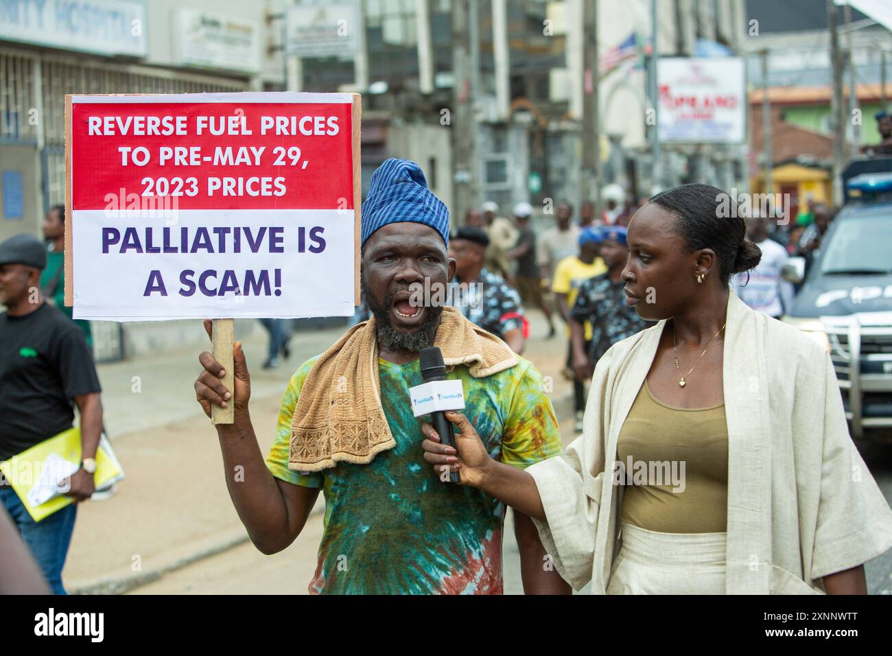 A protester displaying his placard while marching towards Ojota from ...