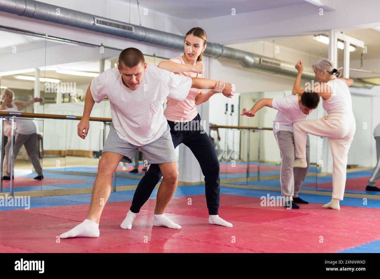 Girl performing elbow strike and wristlock to man in self defence ...
