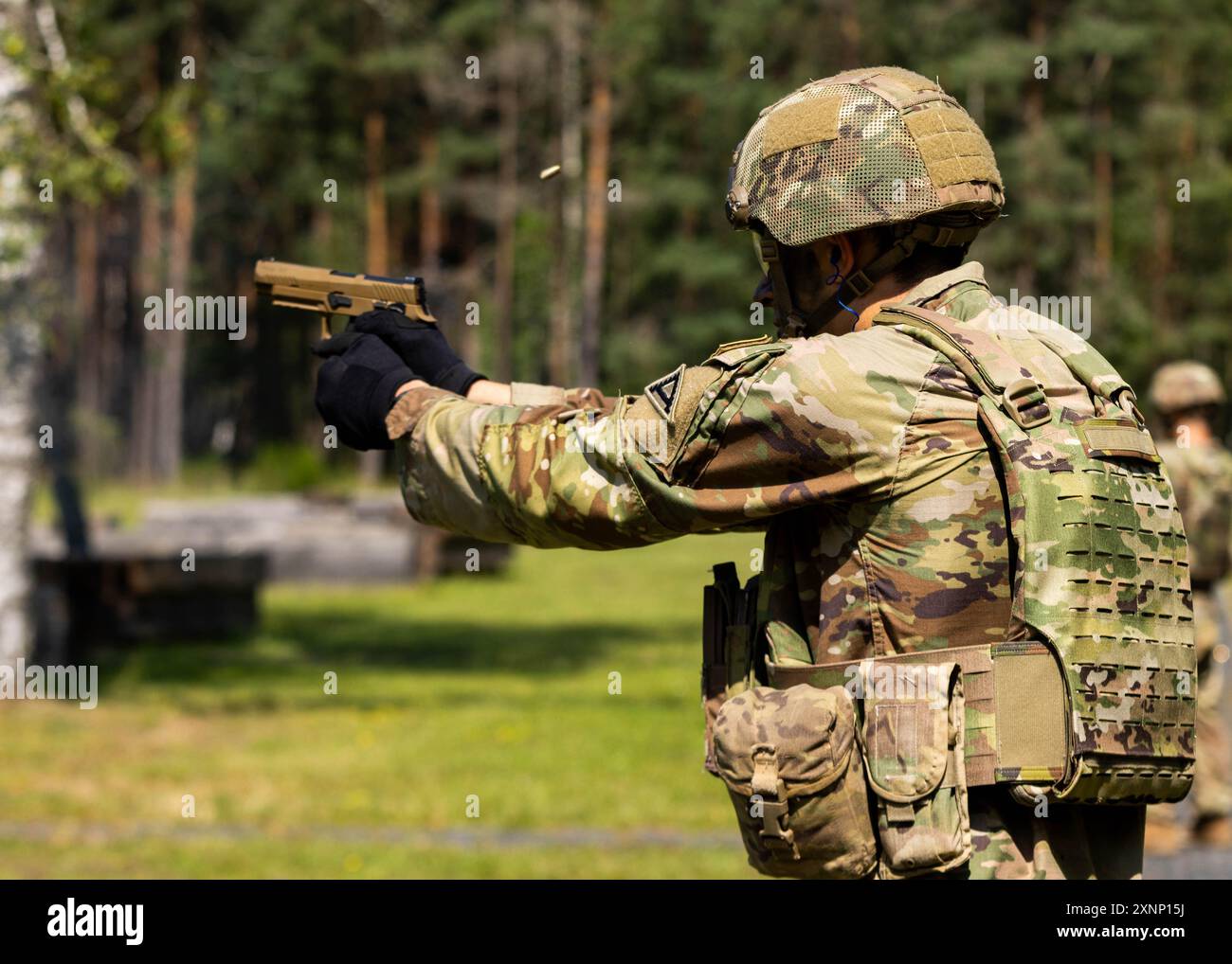 A U.S. Soldier, assigned to the 7th Army Training Command, fires an M17 ...