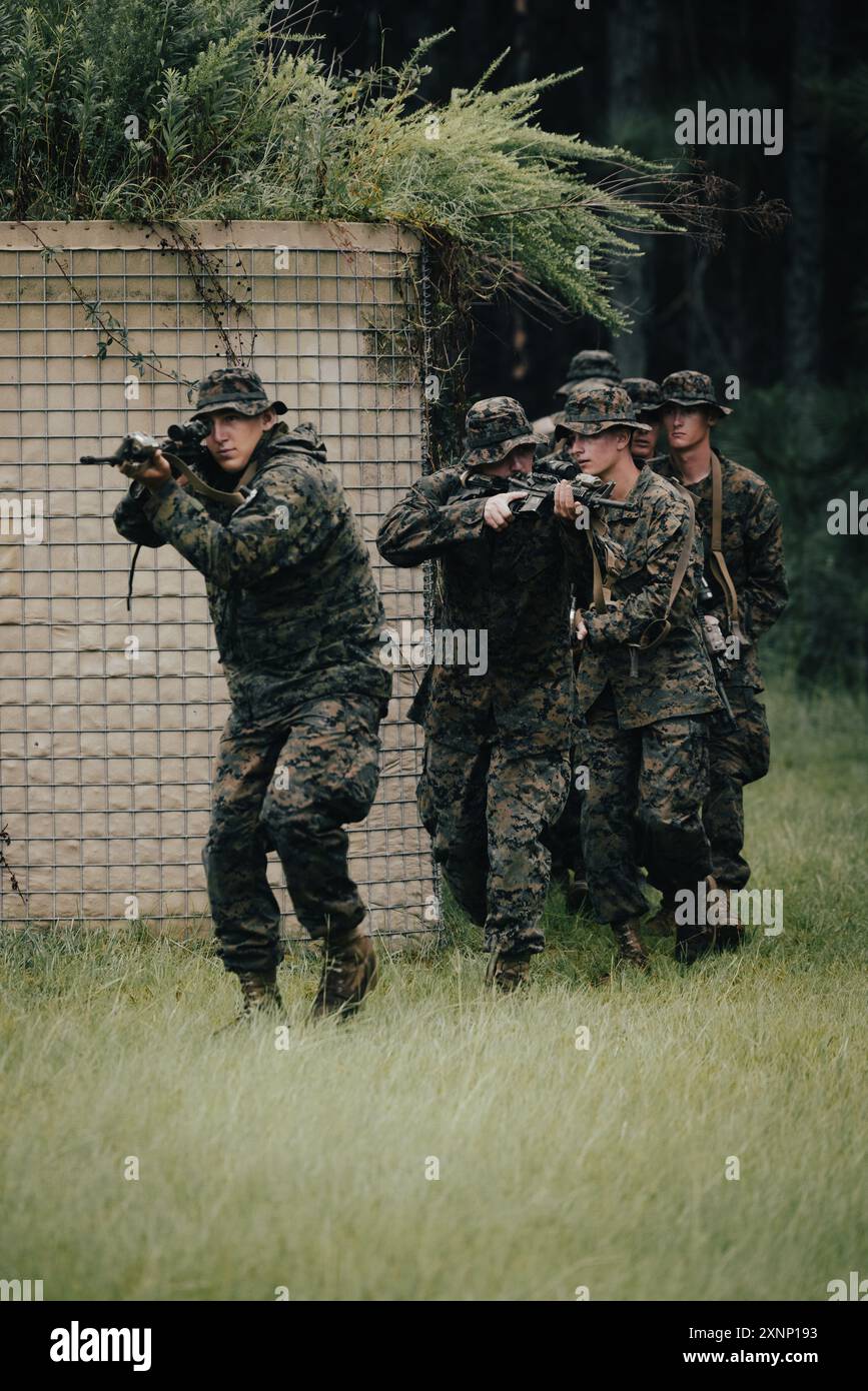 Students with the Naval Reserve Officer Training Corps move to clear a ...