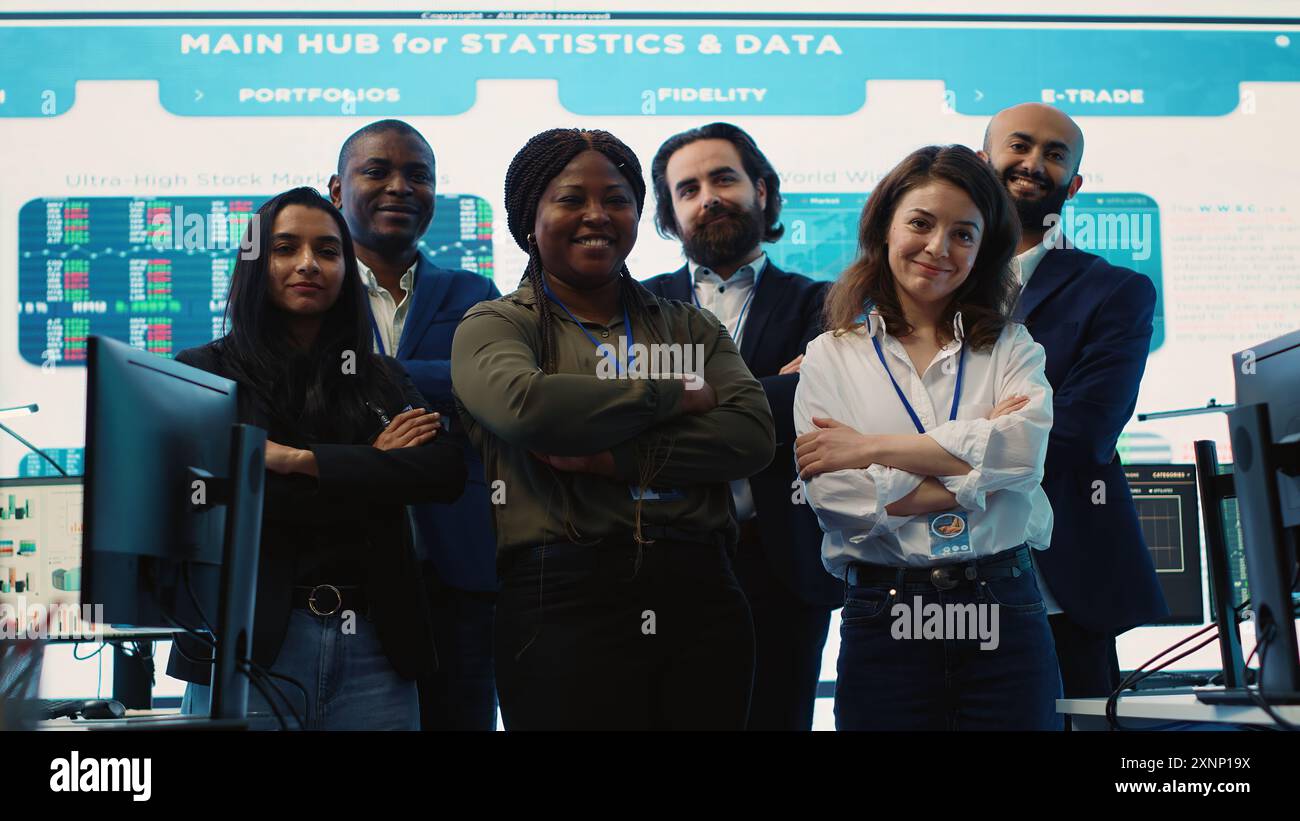 Diverse group of business professionals posing together in monitoring ...