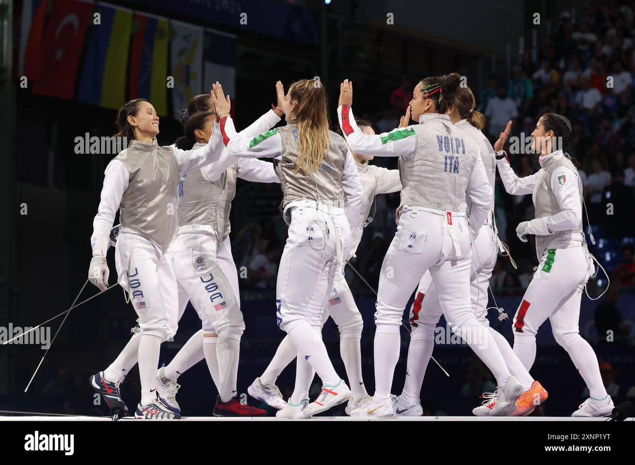 Members of the US give high-fives to their Italian competitors before ...