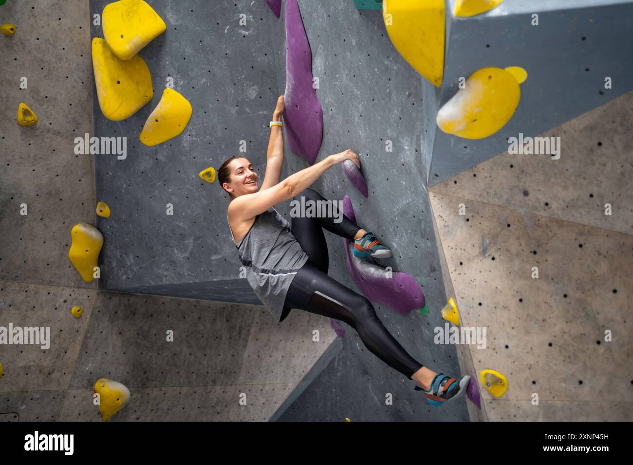 Happy woman climbing exercise mountain at gym. Side view of smiling ...