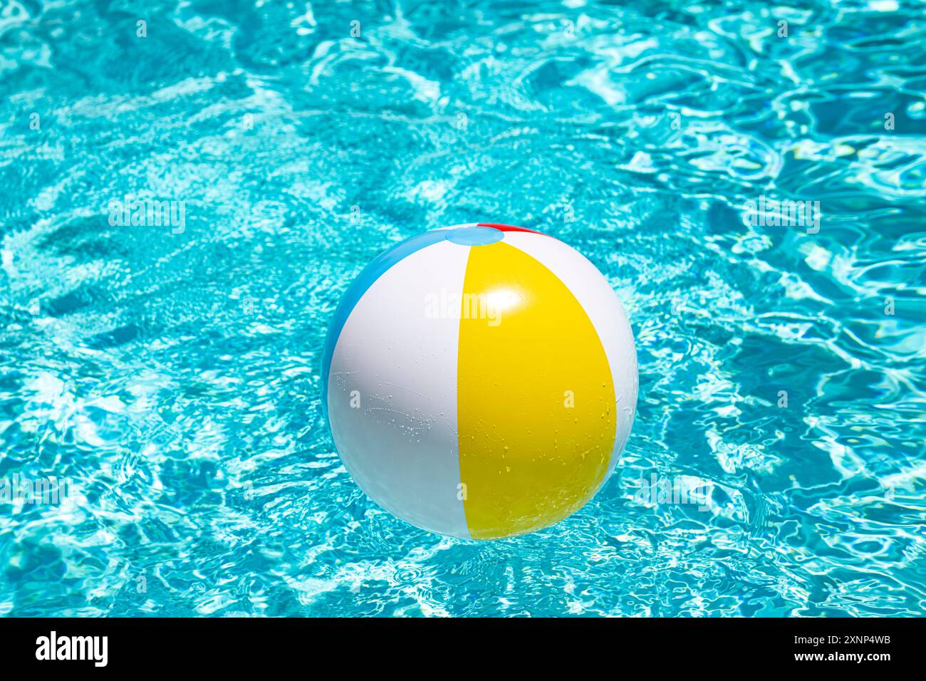 Summer swimming pool. Beach ball in swimming pool. Summer vacation ...