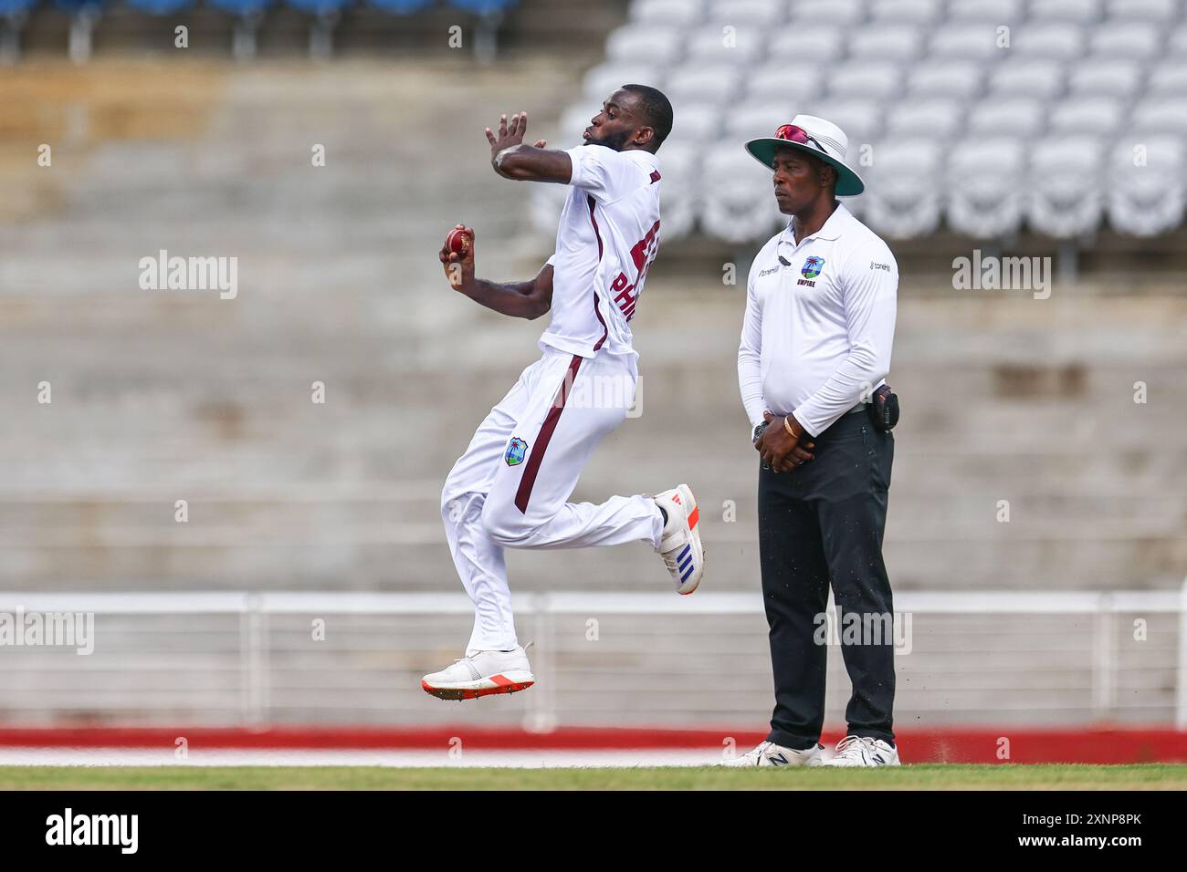August 1, 2024: West Indies' Anderson Phillip, left, bowls while umpire ...