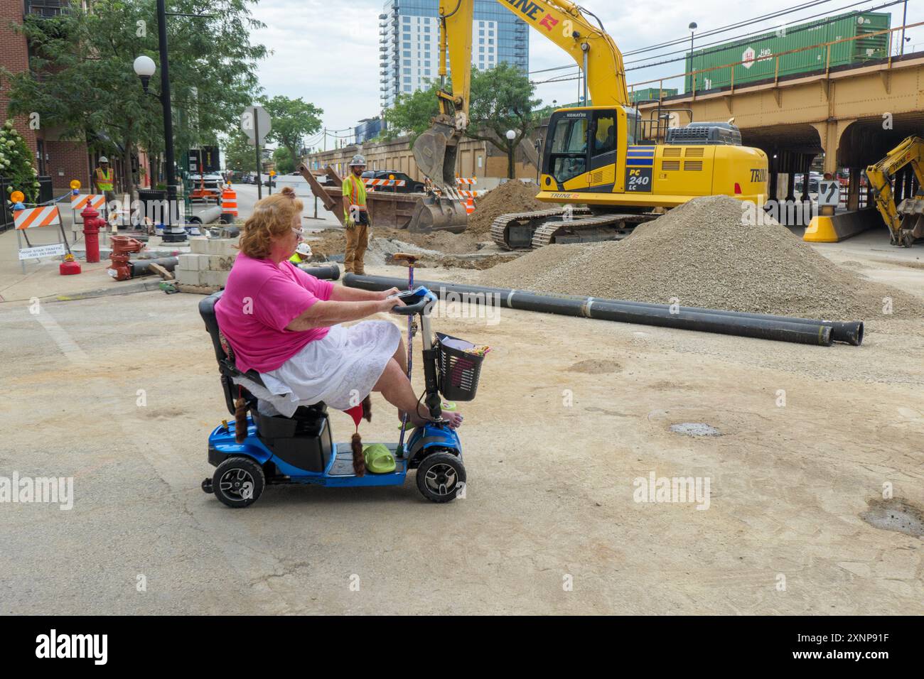 Woman driving mobility scooter through construction zone. Oak Park ...