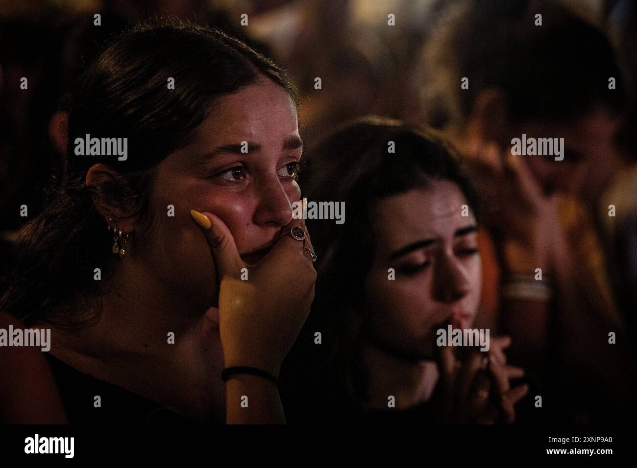 Israeli youth holds back her tears during a rally marking 300 days ...
