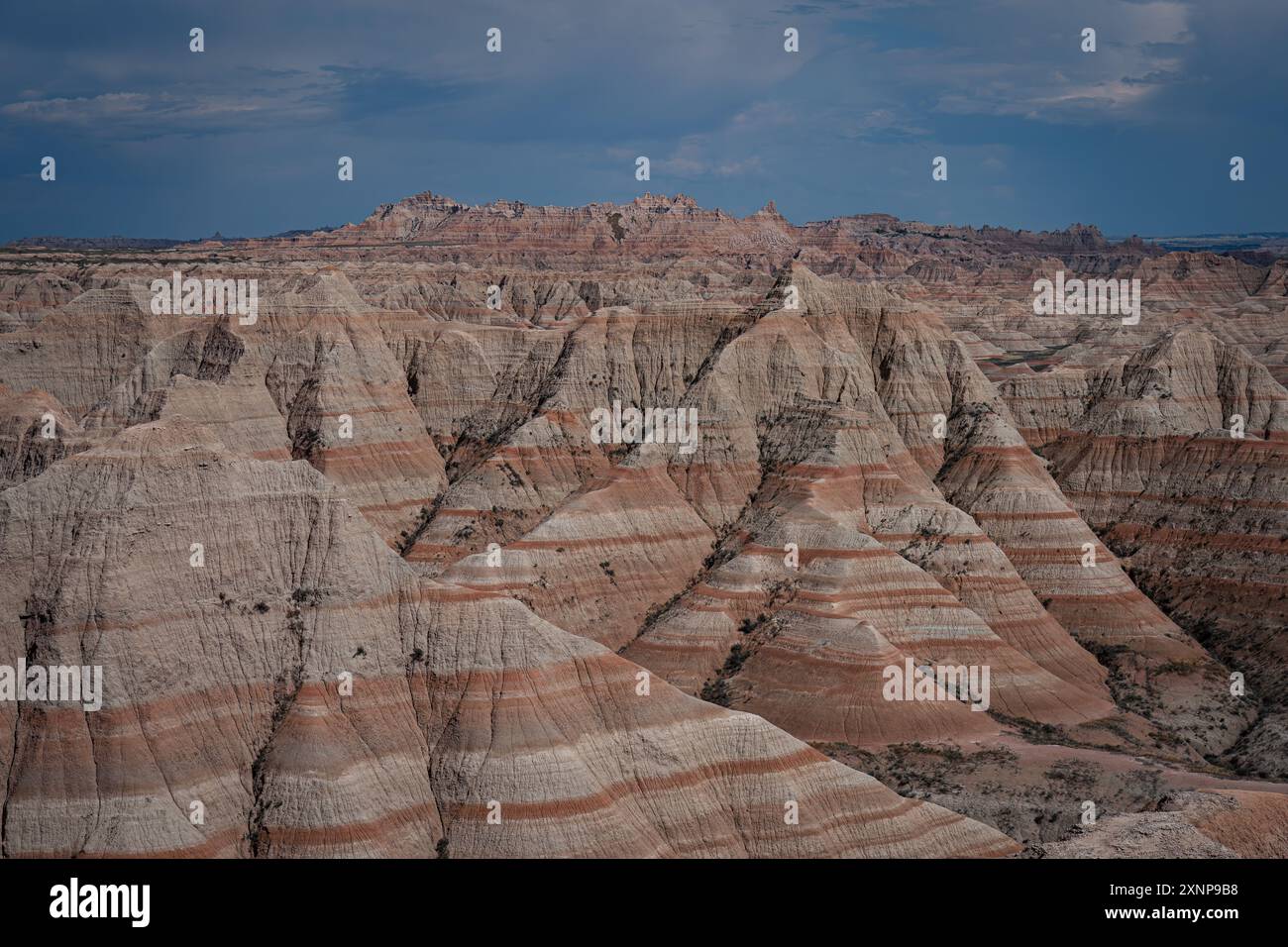 Red Striped Rocks with clouds Stock Photo - Alamy