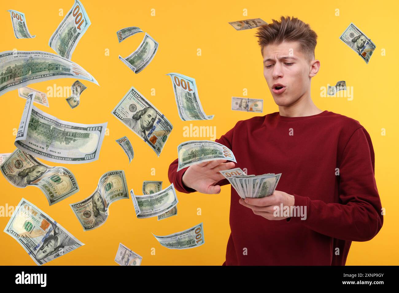 Man throwing money on orange background. Dollar bills in air Stock ...