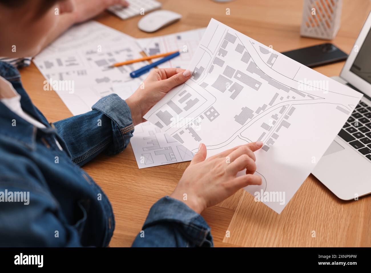 Cartographer working with cadastral map at wooden table, closeup Stock ...