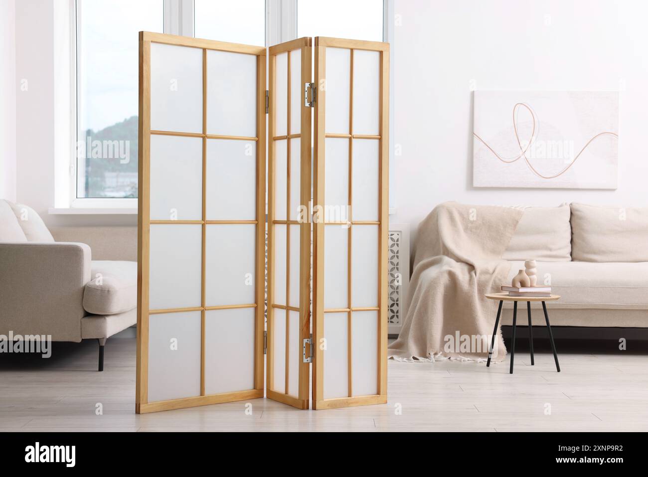 Folding screen, sofas and side table in living room Stock Photo - Alamy