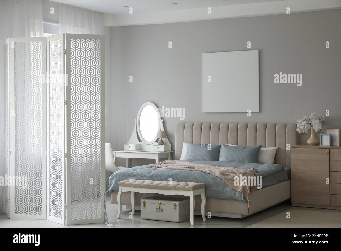 Folding screen, mirror and comfortable bed in bedroom. Interior design ...