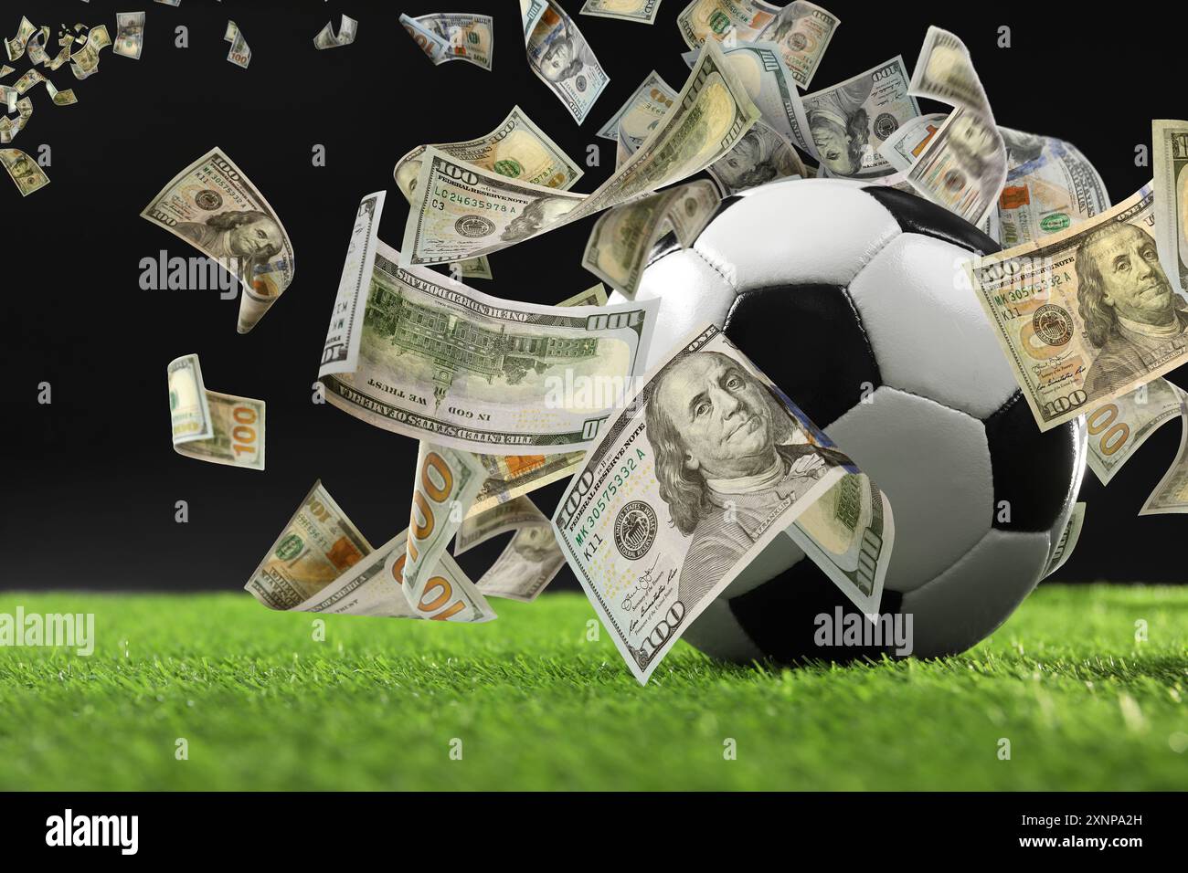 Money flying from soccer ball on stadium Stock Photo - Alamy